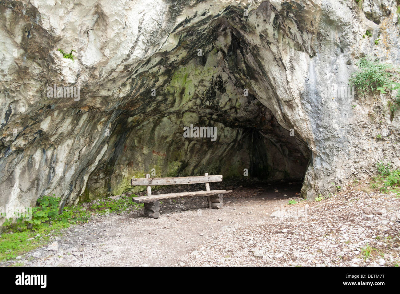 Seat in front of a cave Stock Photo - Alamy