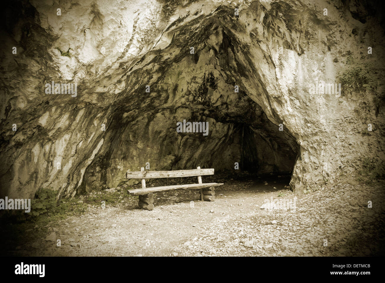 Seat in front of a cave Stock Photo - Alamy