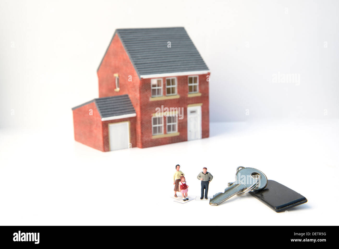 Family home concept with model house and people on white background ...