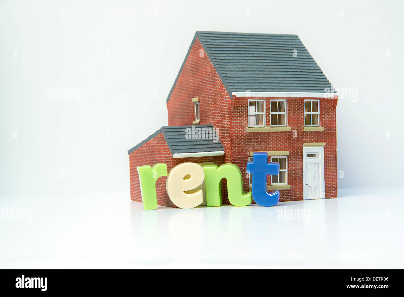 Rent lease house concept with model house and letters Stock Photo - Alamy