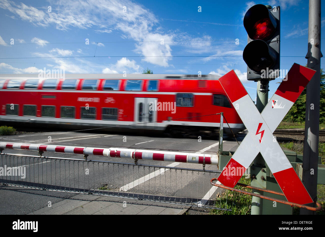 A regional train passes a railroad crossing in Meerbusch, Germany, 17 ...