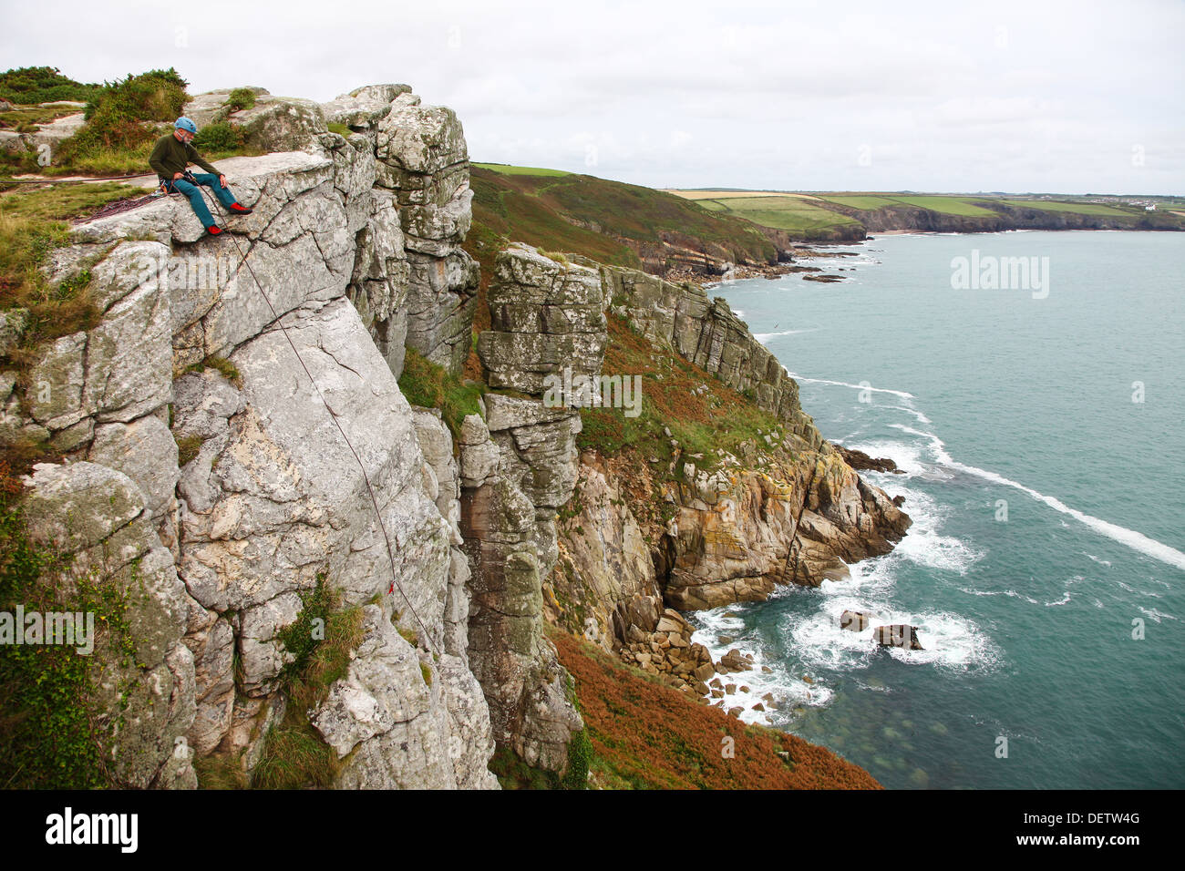 A climber on top of Rinsey Cliffs in south west Cornwall England UK ...