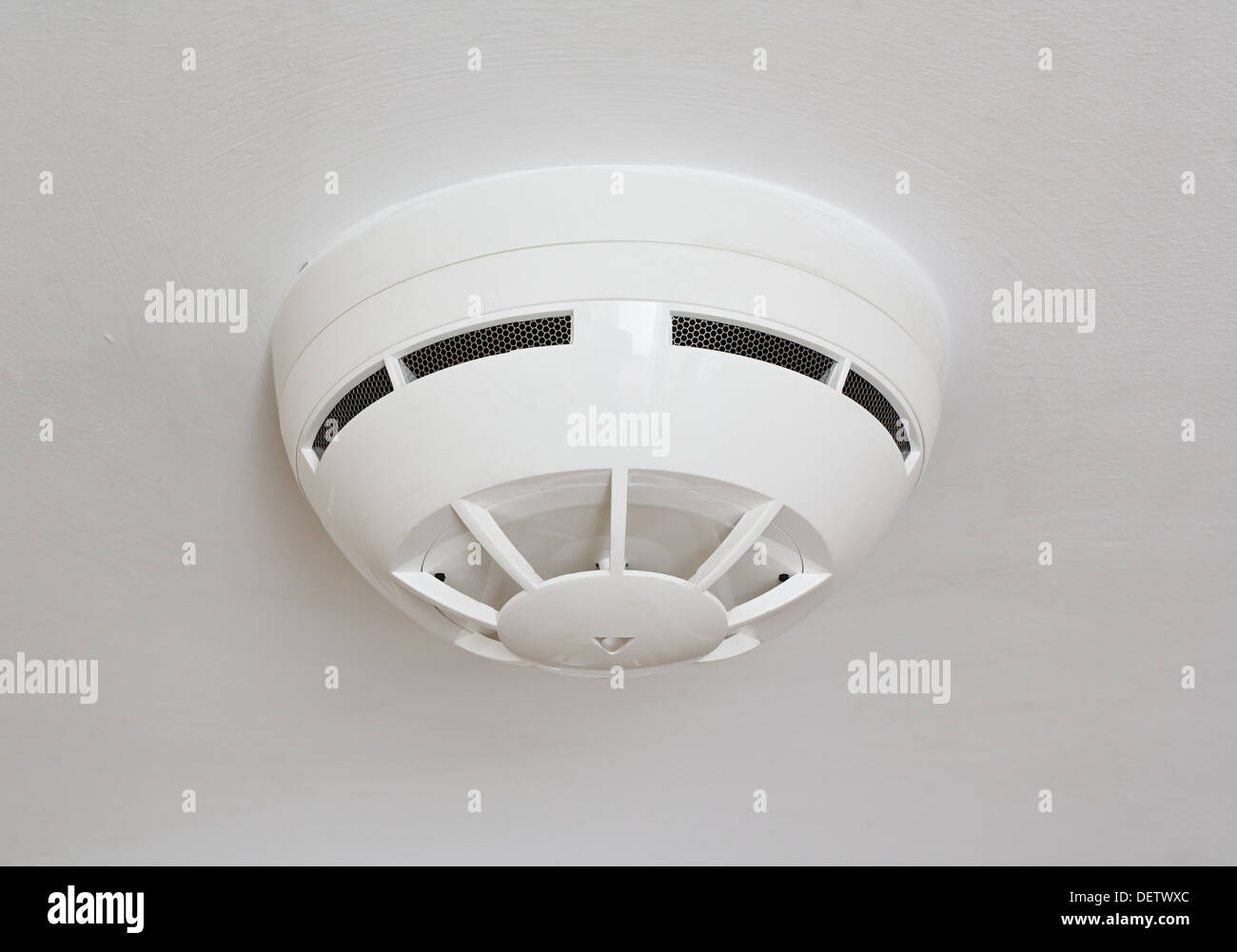 ceiling mounted white fire detector used to activate warning systems in ...