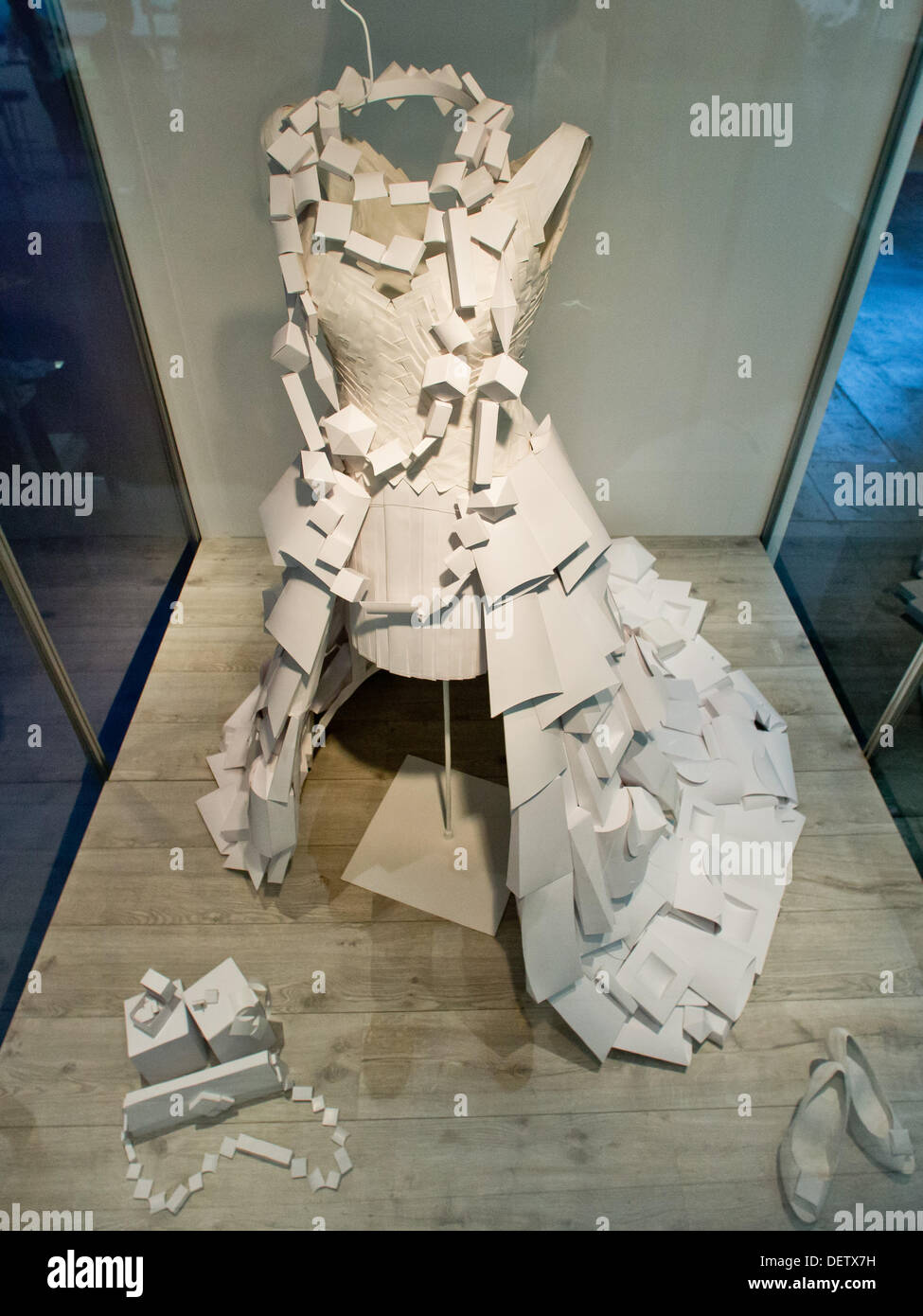 A paper evening dress made of packaging of different shapes and sizes ...