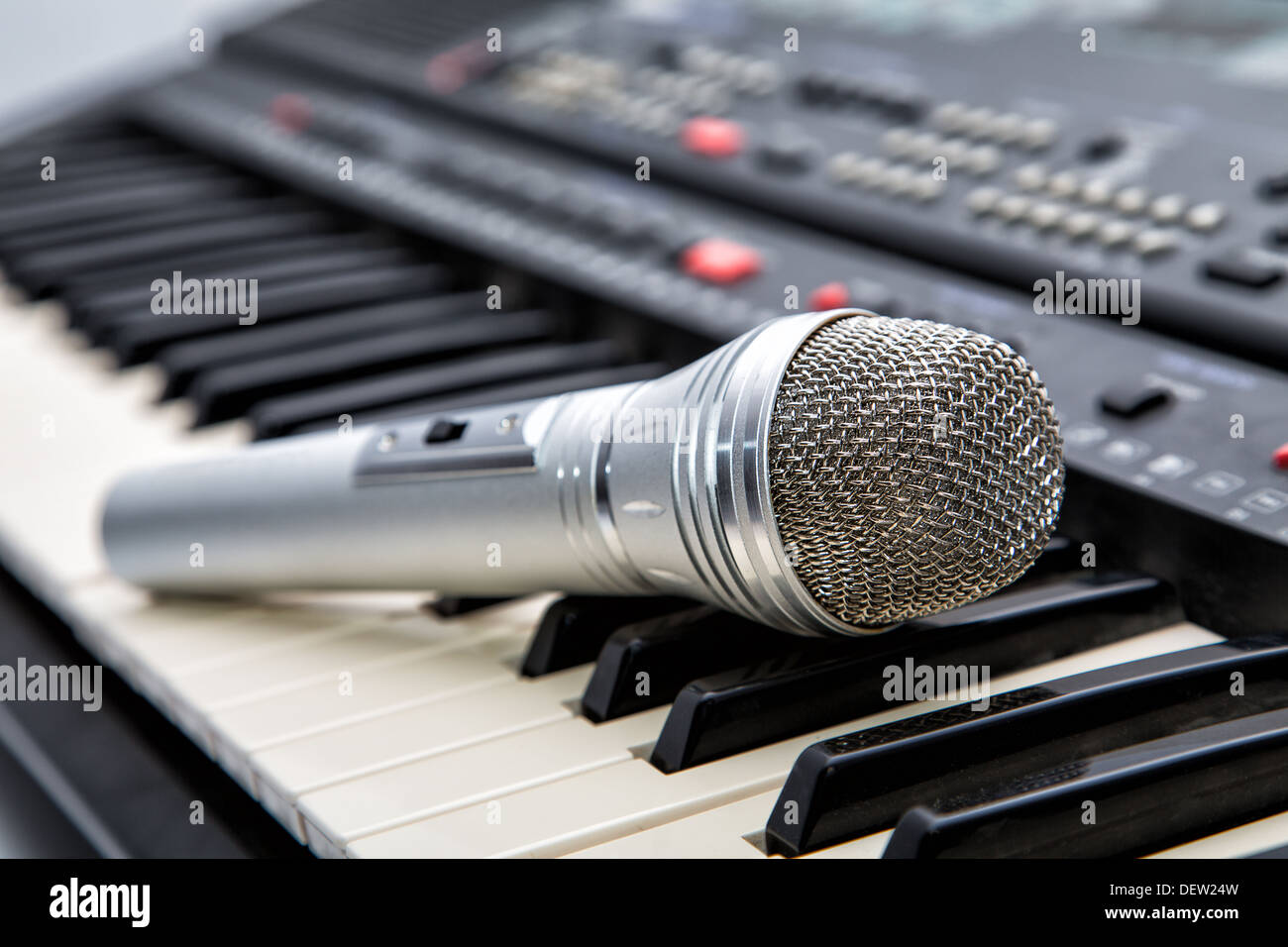 Microphone on keys of a musical synthesizer Stock Photo - Alamy