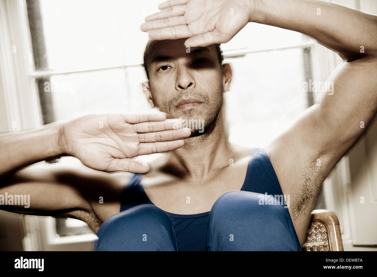 Hispanic man posing in front of a window Stock Photo - Alamy