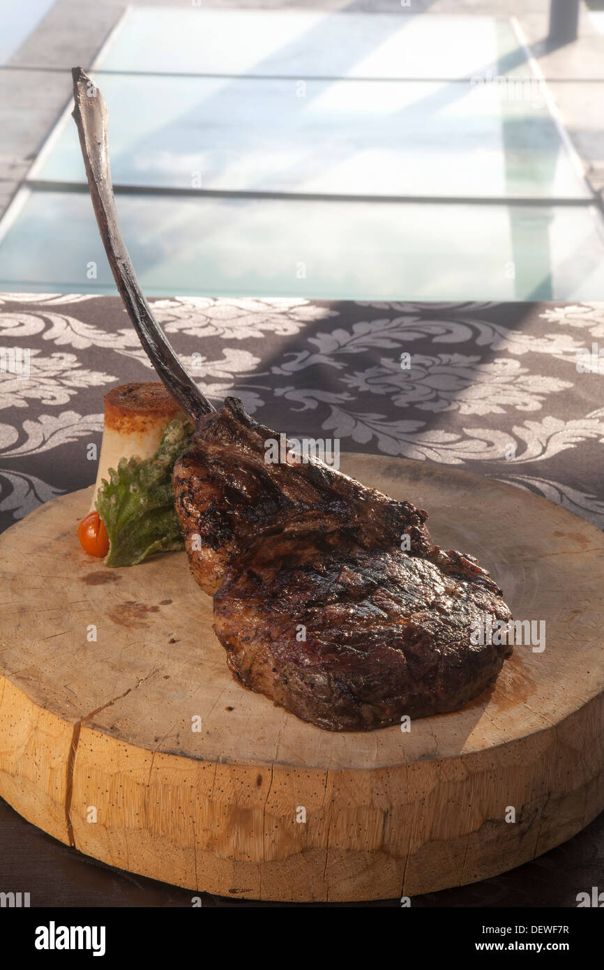 Very big steak served with rice, tomatoes and green vegetable on big ...