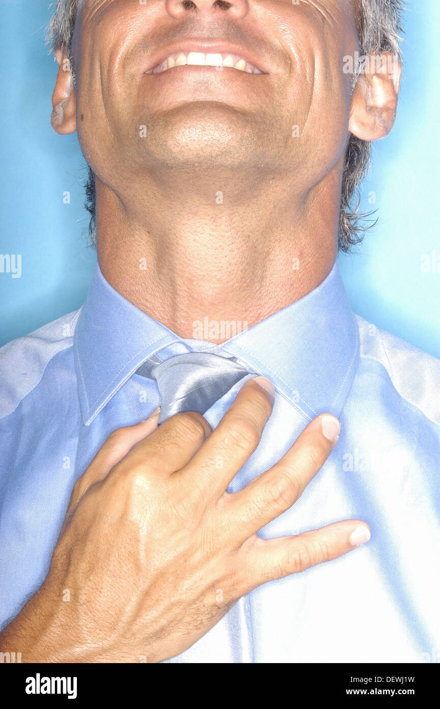 Caucasian mid adult man pulling necktie hi-res stock photography and ...
