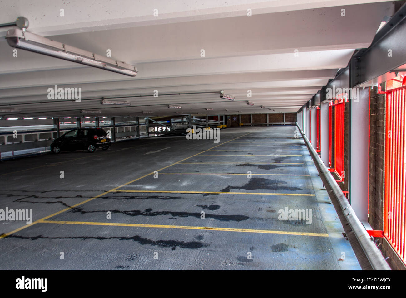Multi-story car park with 4 vehicles parked at the far end Stock Photo ...
