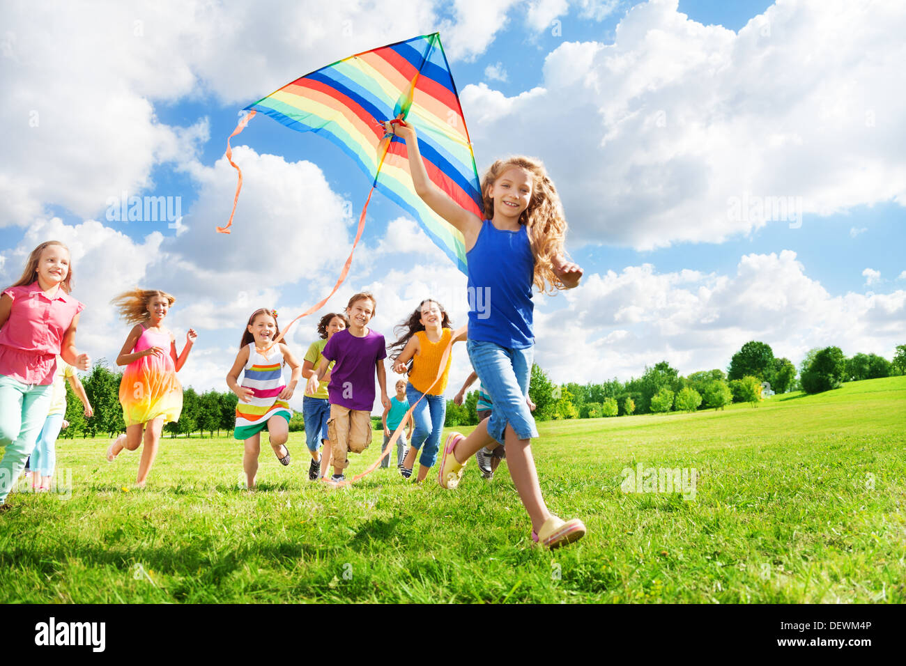 Happy smiling girl with long hair with other kids boys and girls ...
