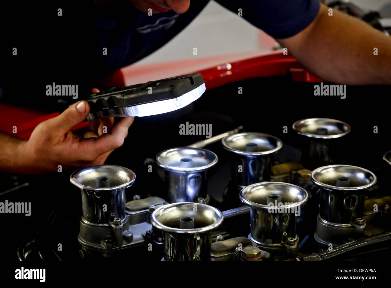 An engineer checks out the air intakes on a race car Stock Photo - Alamy