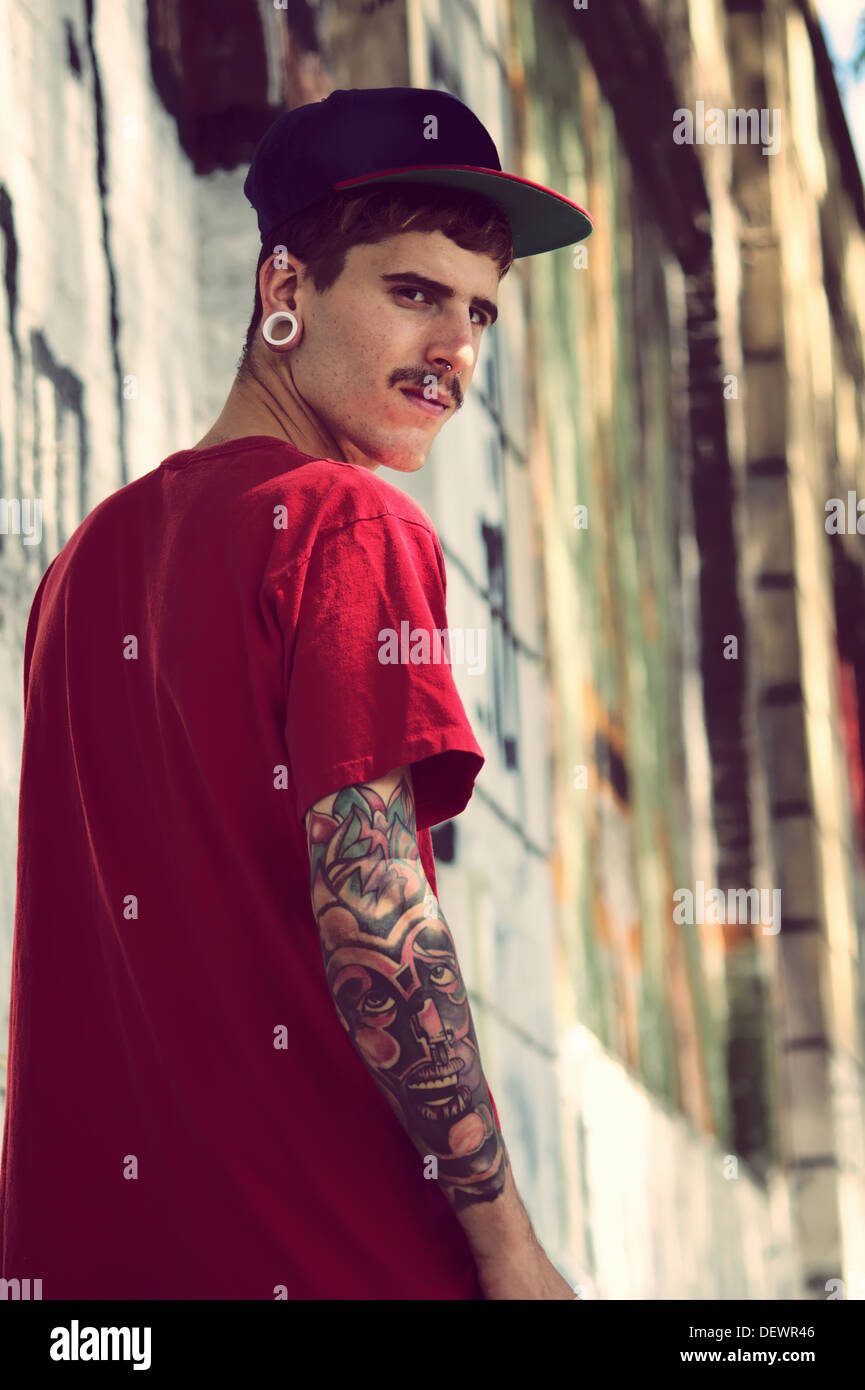 A young Rapper walking down a urban street Stock Photo - Alamy