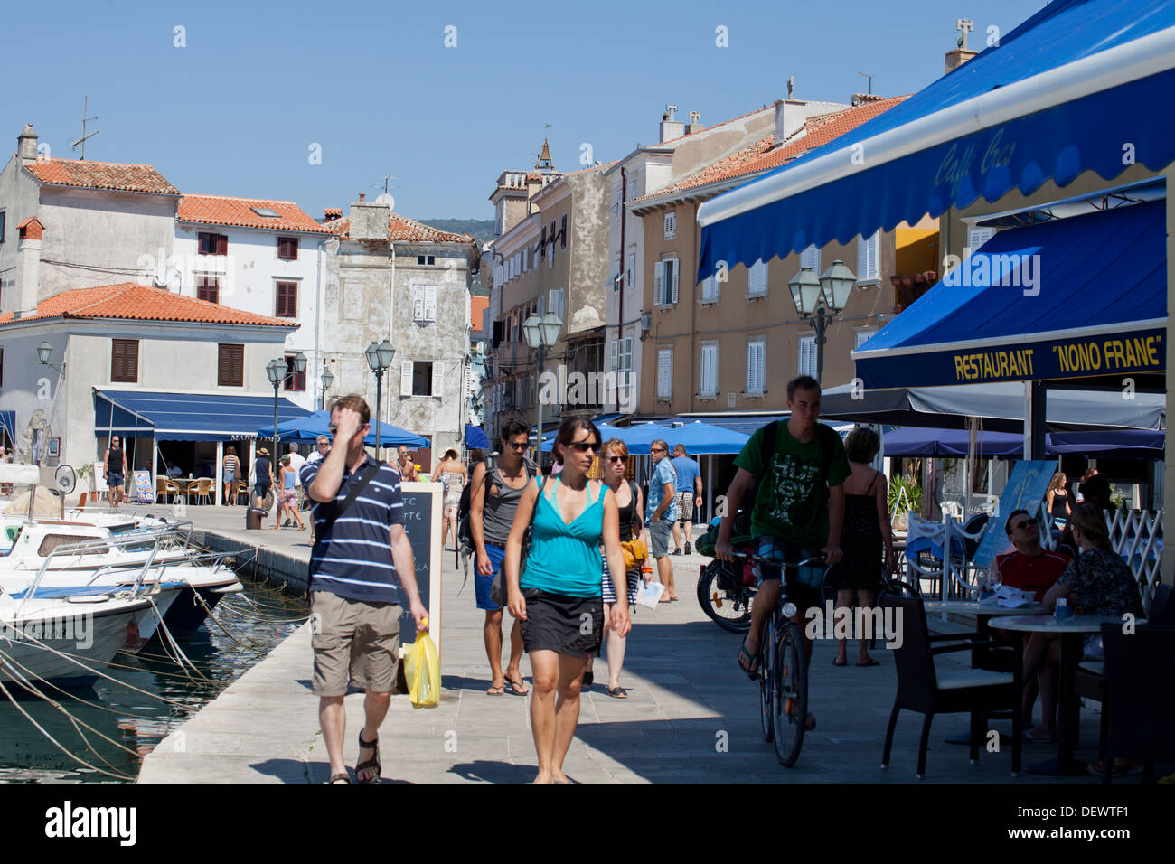Cres town harbor on the island of Cres, Croatia. Tourists walking along ...