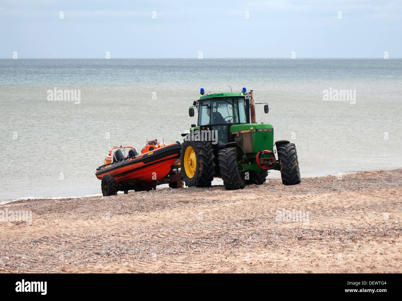 Henry the Tractor pulling up a lifeboat dinghy on Hornsea Beach in East ...