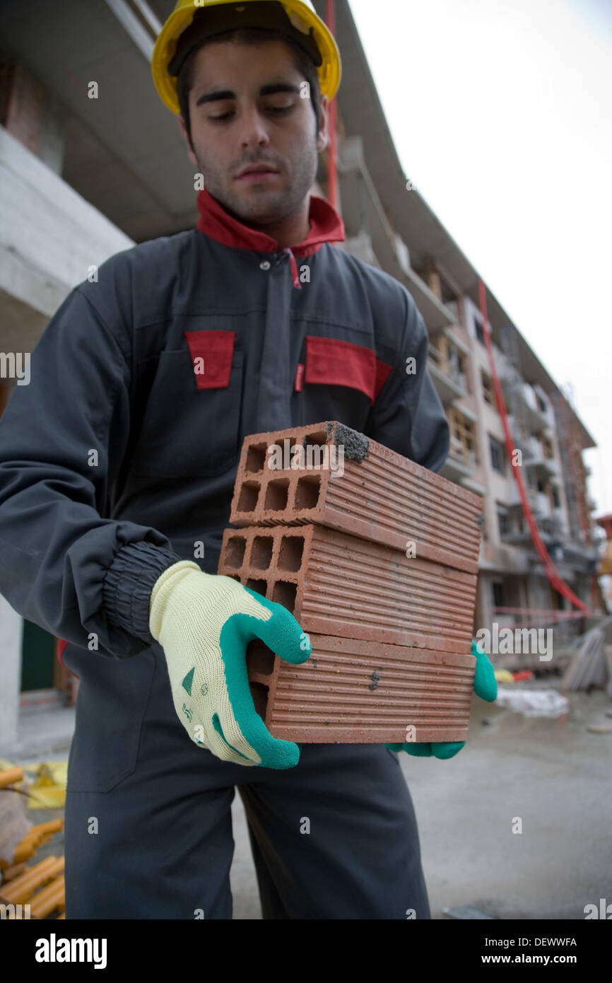 Man carrying bricks hi-res stock photography and images - Alamy