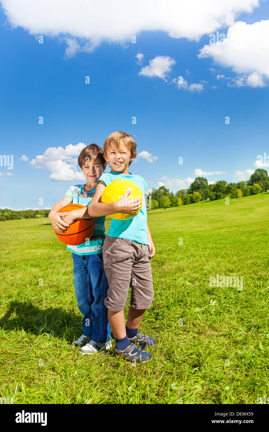 Two boys stand football hi-res stock photography and images - Alamy