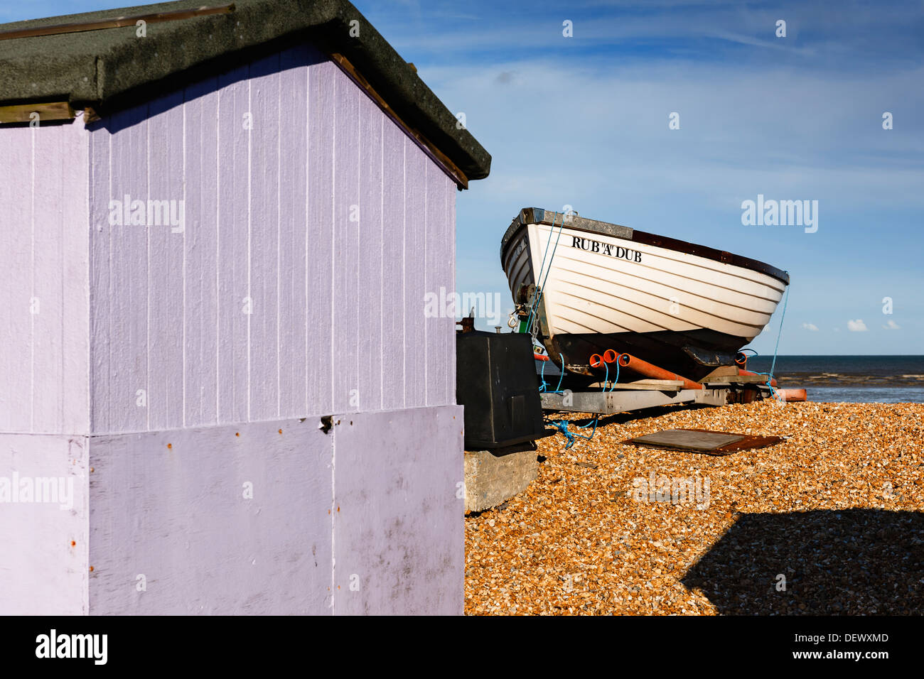 A boat and a beach hut on Greatstone Beach, New Romney, Kent, UK Stock ...