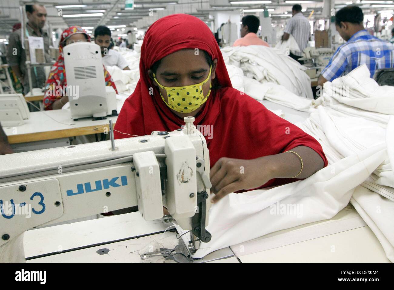 Dhaka, Bangladesh . 24th Sep, 2013. Bangladeshi woman works in a ...