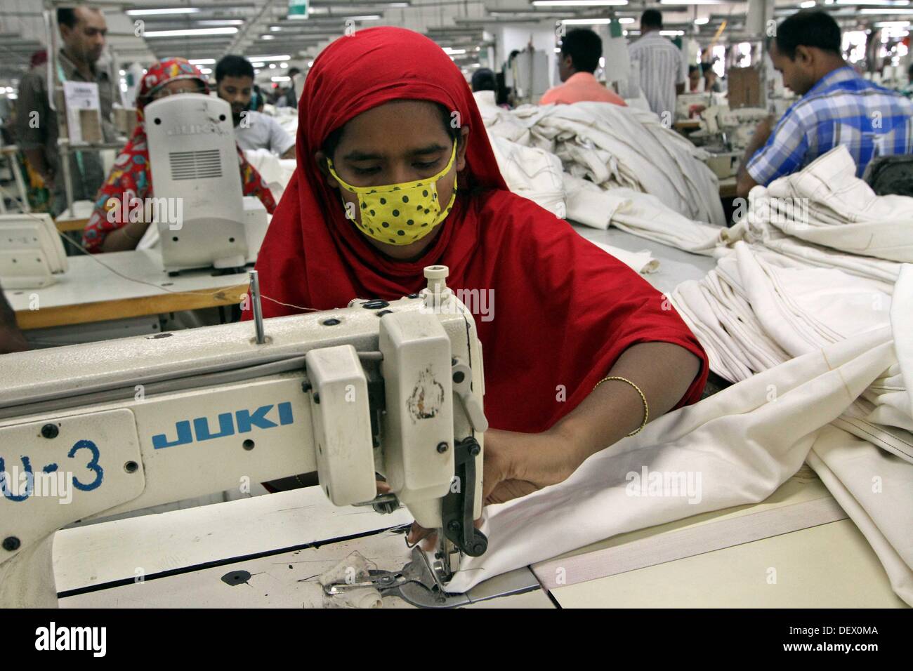 Dhaka, Bangladesh . 24th Sep, 2013. Bangladeshi woman works in a ...