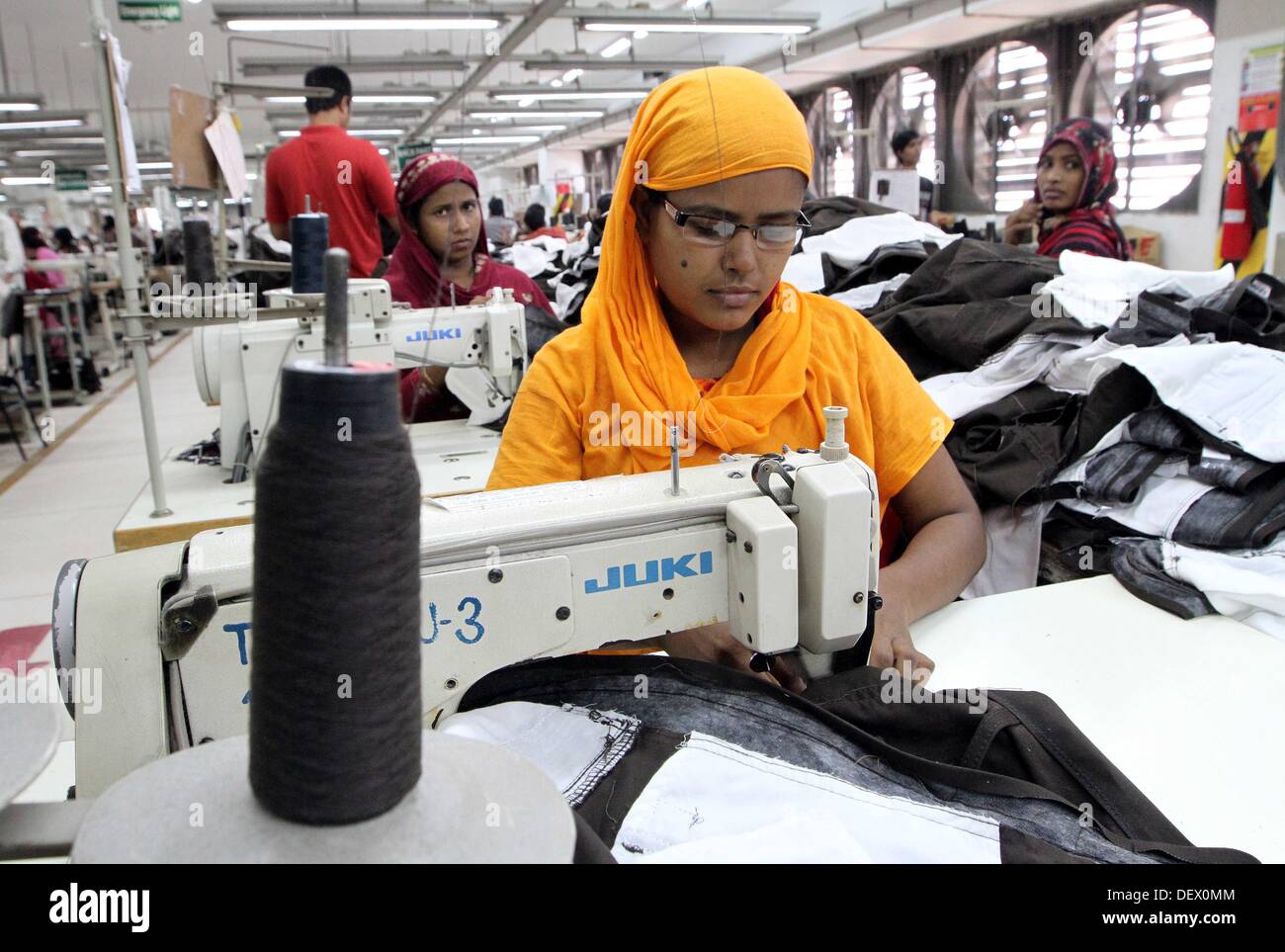 Dhaka, Bangladesh . 24th Sep, 2013. Bangladeshi woman works in a ...