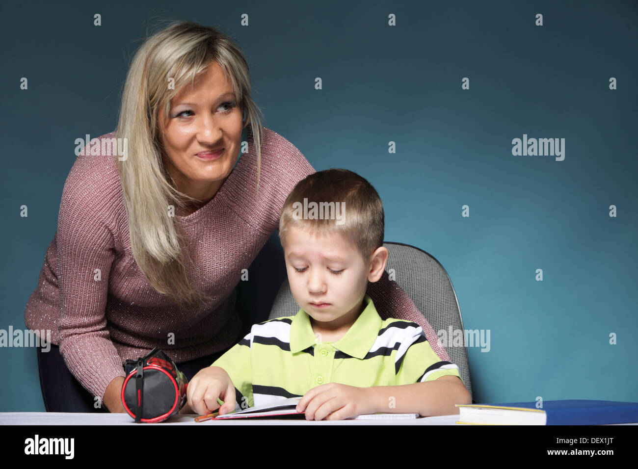 mother and son drawing together, mom helping with homework daycare blue ...