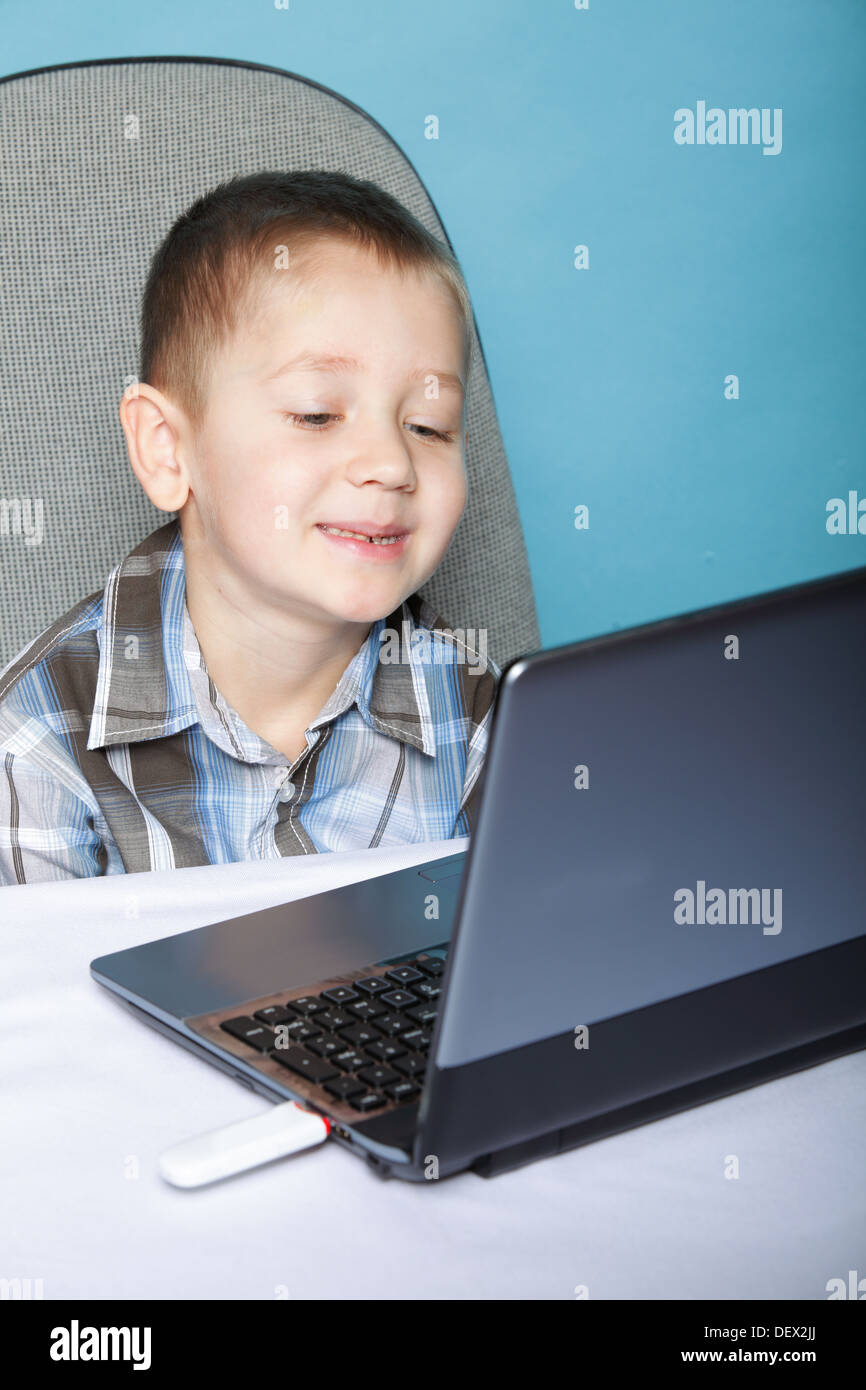 Computer addiction child boy with laptop notebook blue background Stock ...