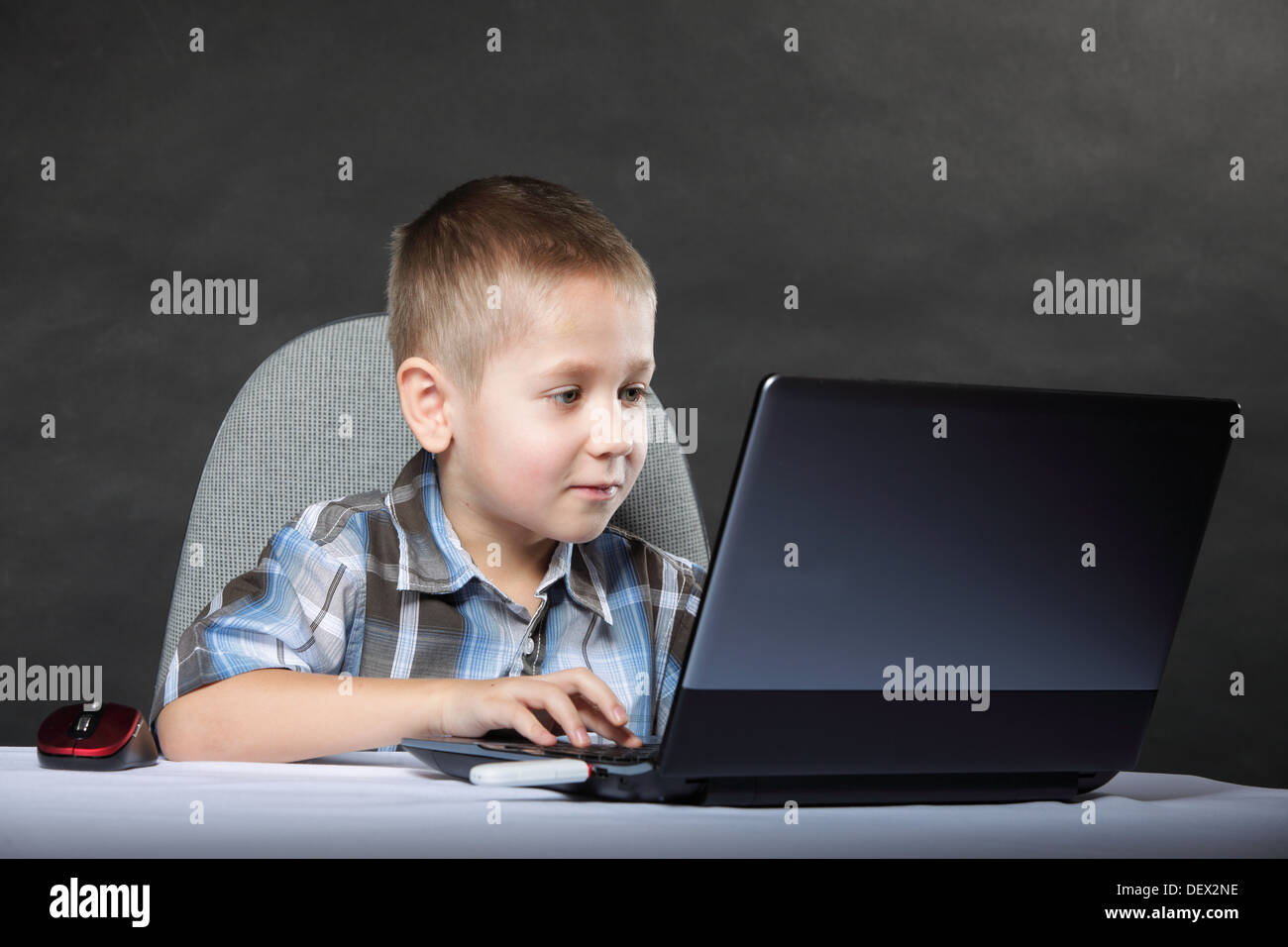 Computer addiction child boy with laptop notebook black background ...