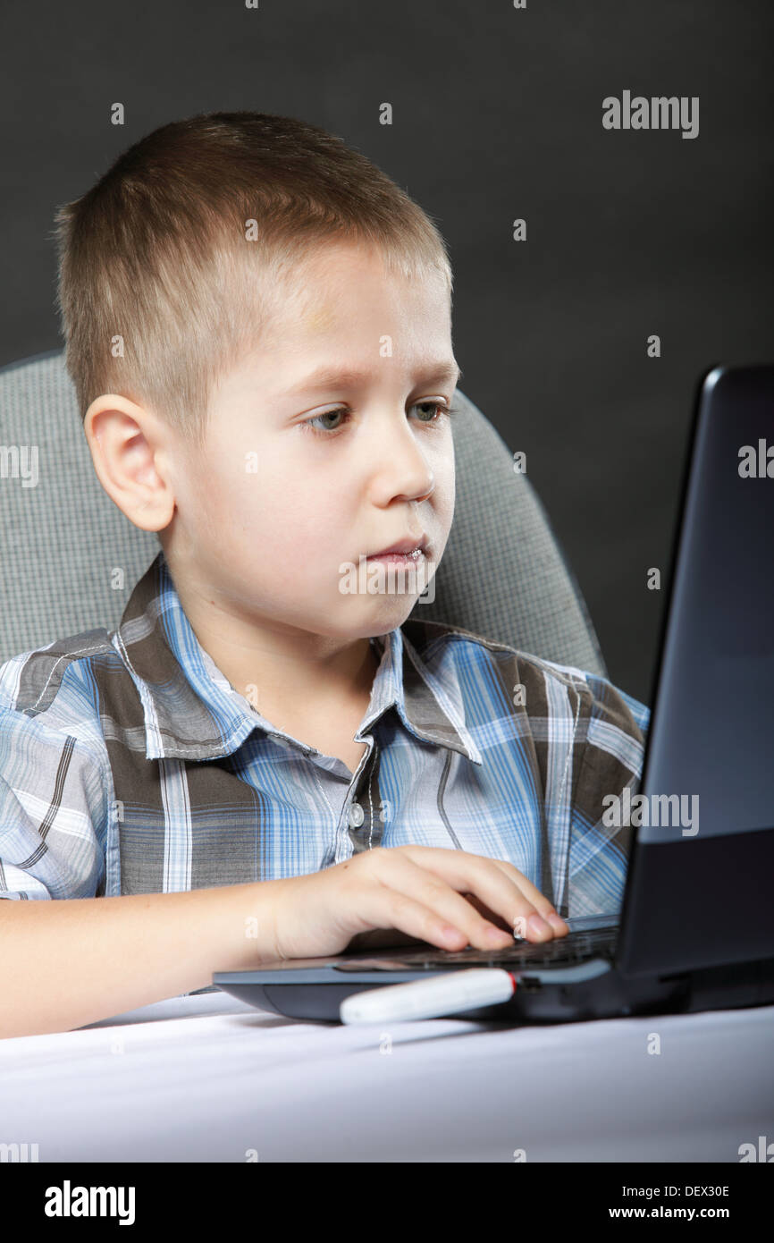 Computer addiction child boy with laptop notebook black background ...