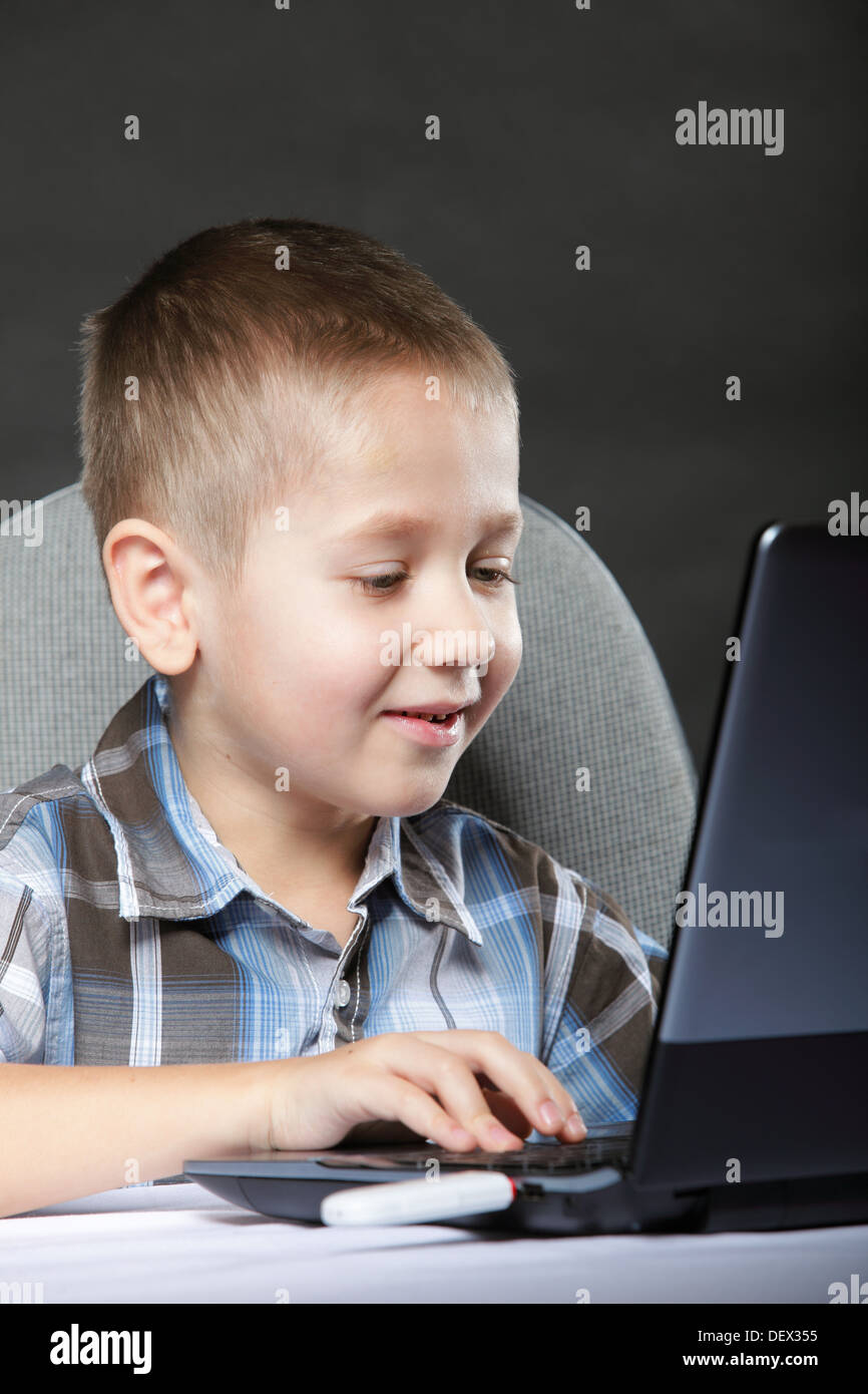Computer addiction child boy with laptop notebook black background ...