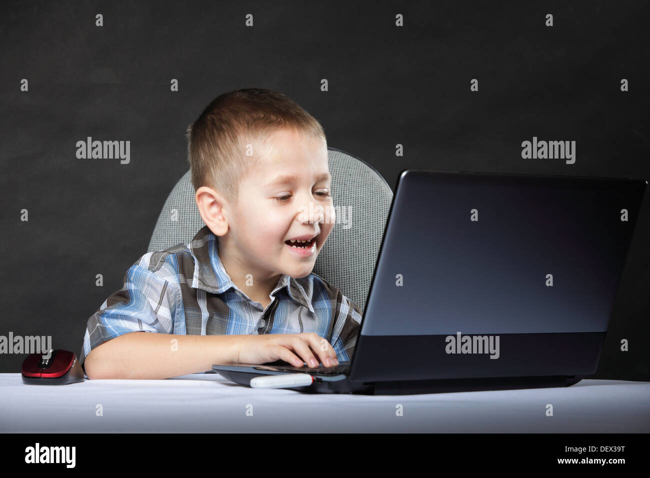 Computer addiction child boy with laptop notebook black background ...