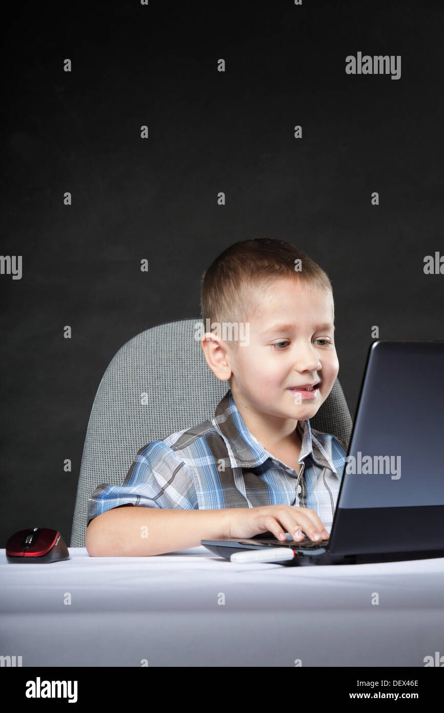 Computer addiction child boy with laptop notebook black background ...