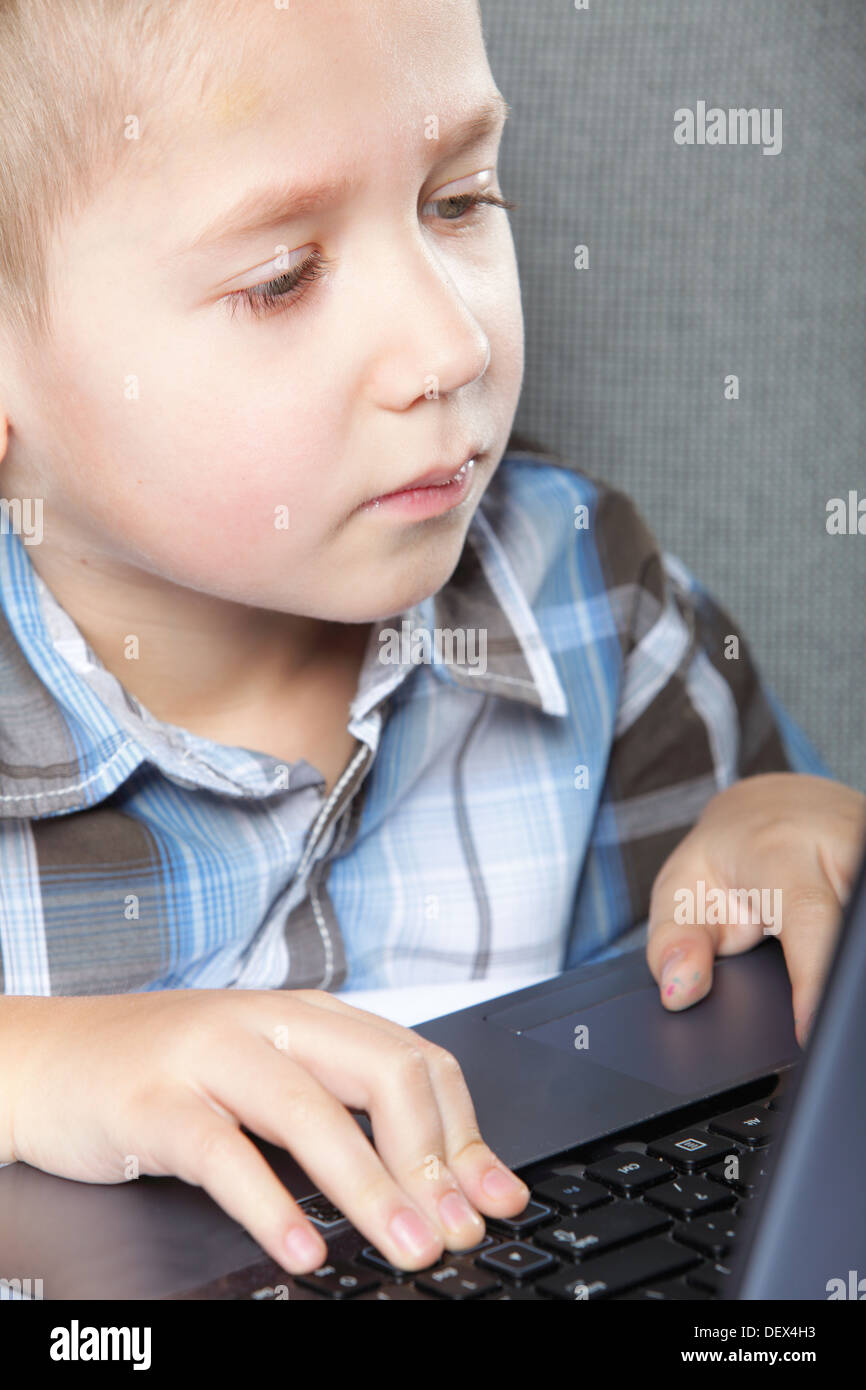 Computer addiction child boy with laptop notebook black background ...
