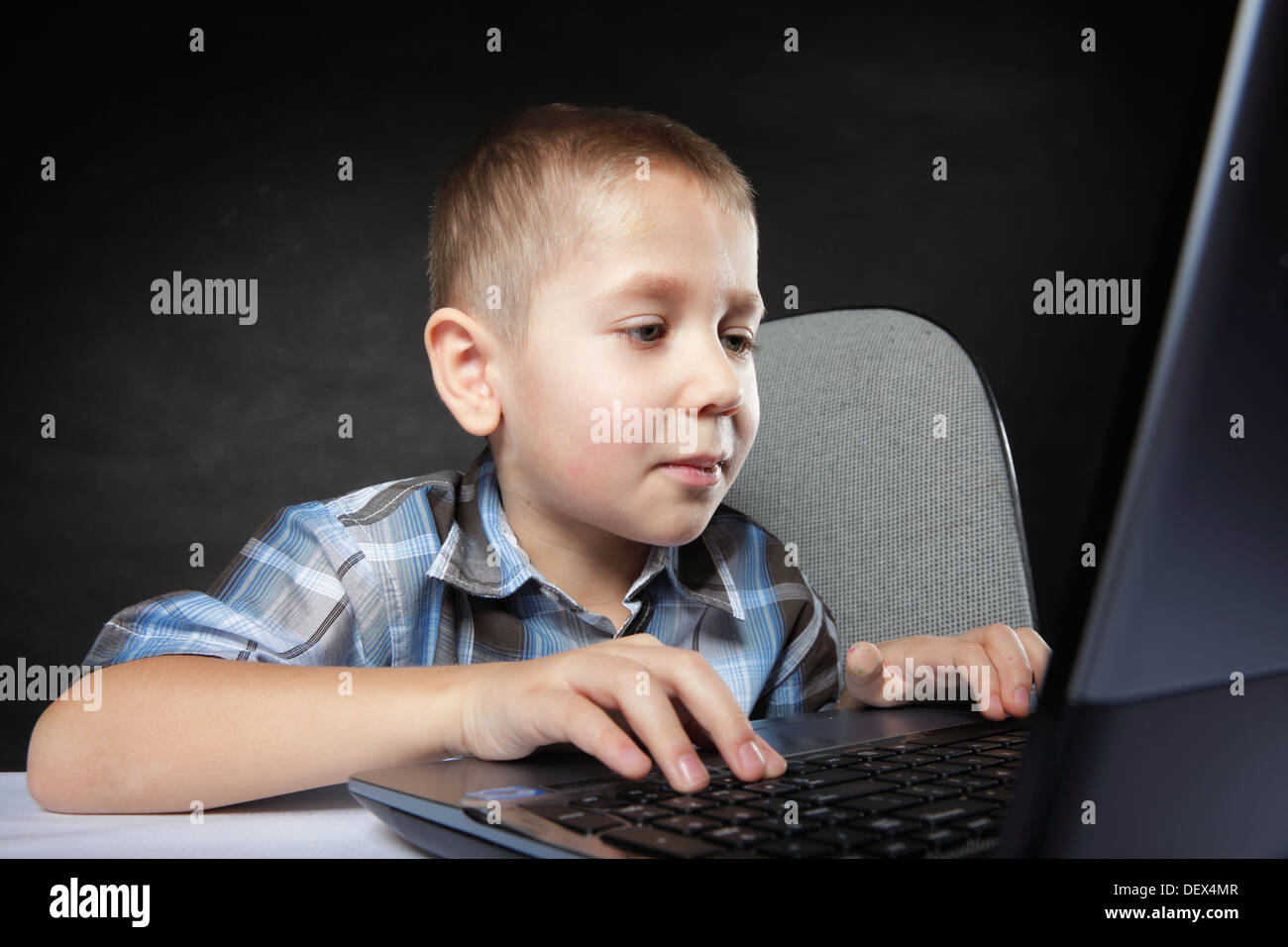 Computer addiction child boy with laptop notebook black background ...