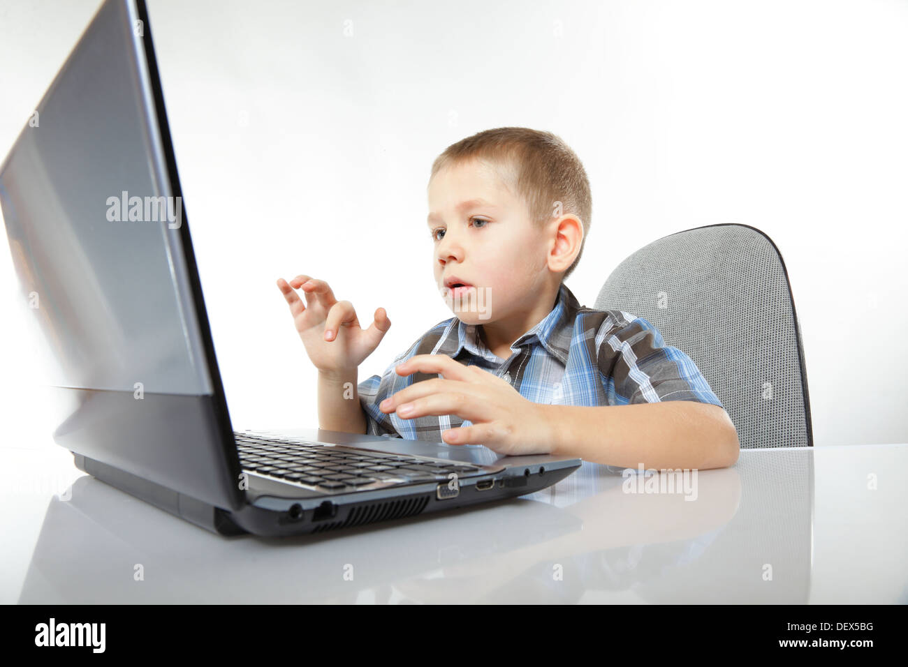Computer addiction emotional child boy with laptop notebook playing ...