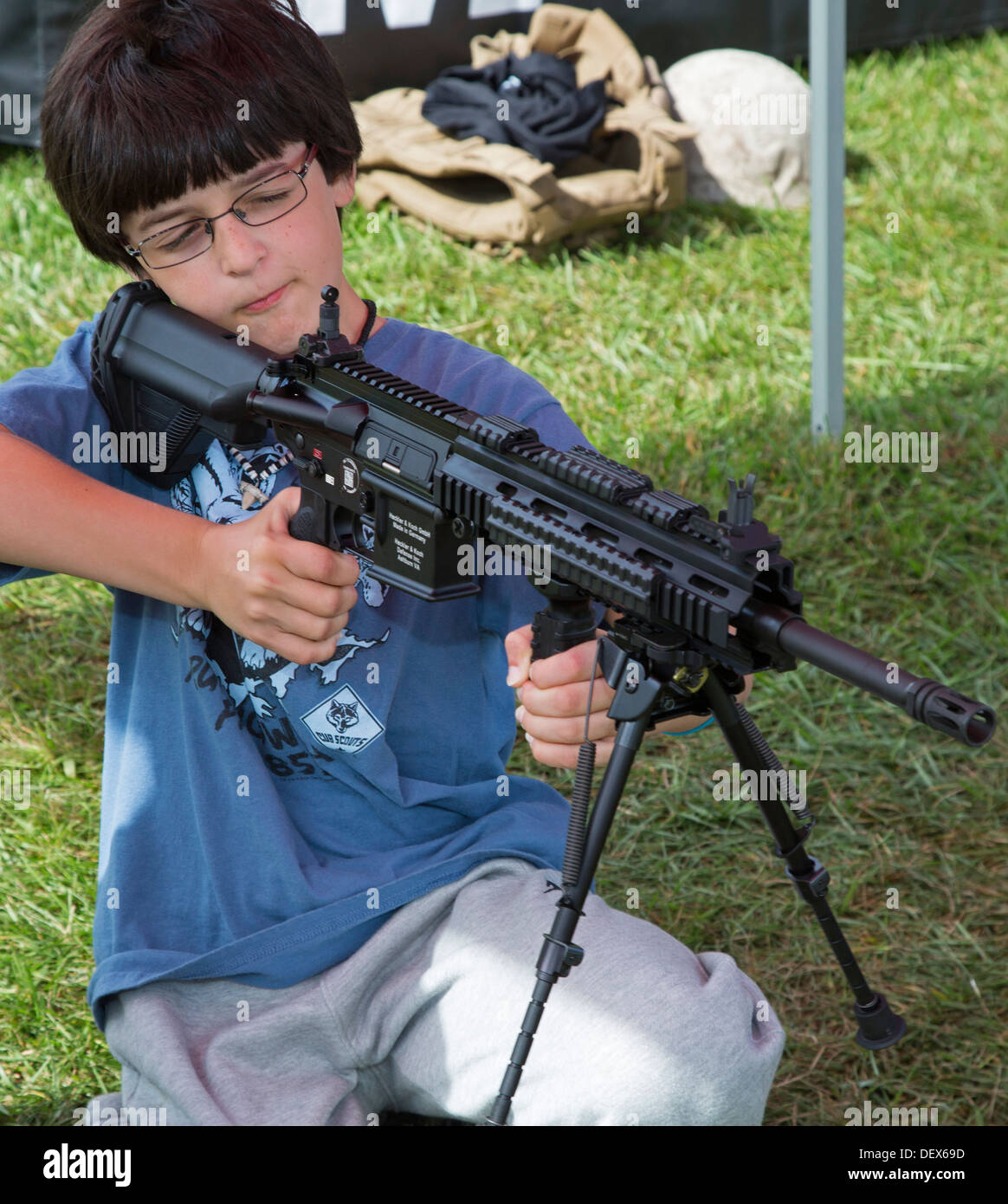 A Boy Scout handles a weapon at a Marine Corps booth during a weekend ...