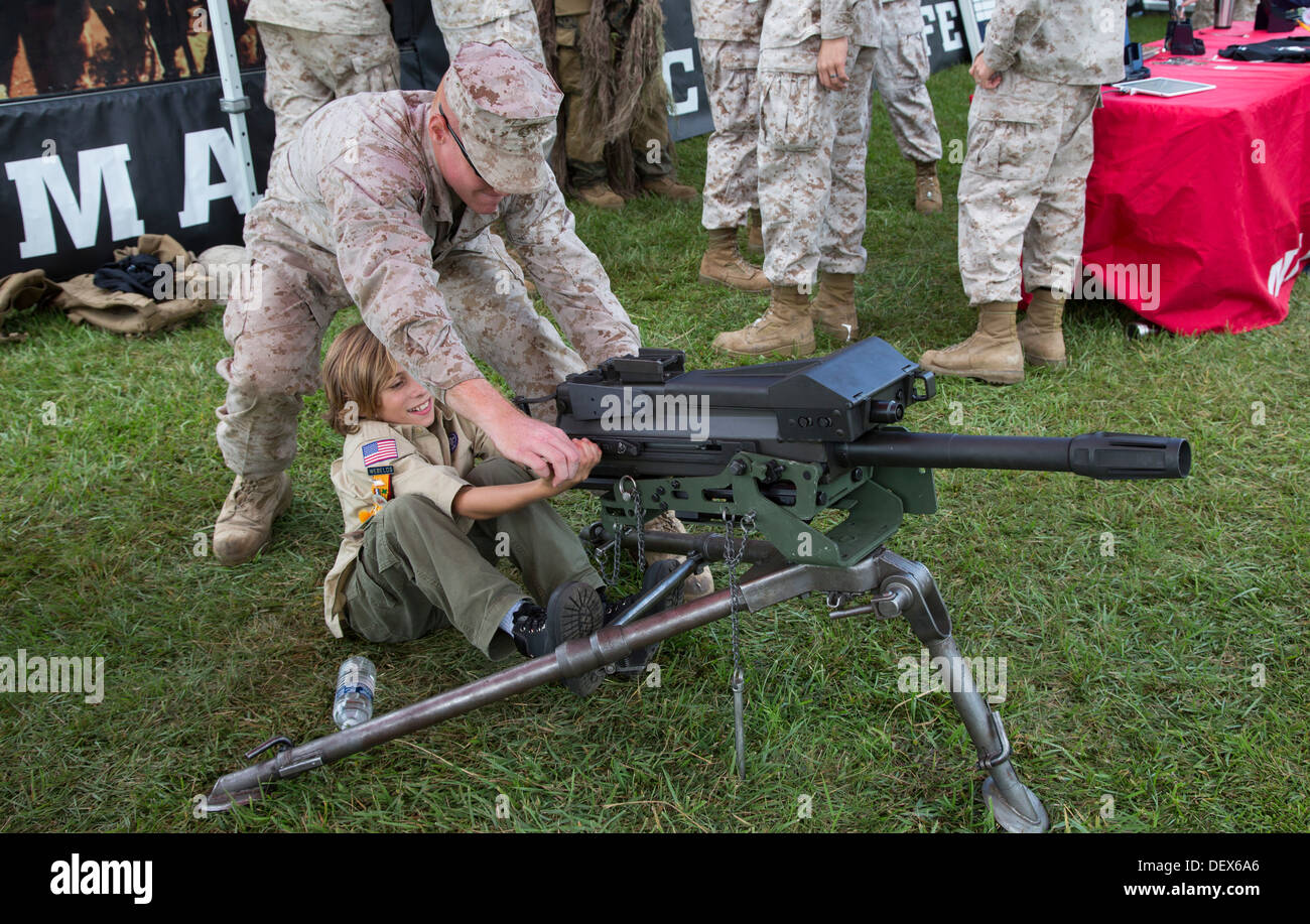 A Boy Scout handles a weapon at a Marine Corps booth during a weekend ...