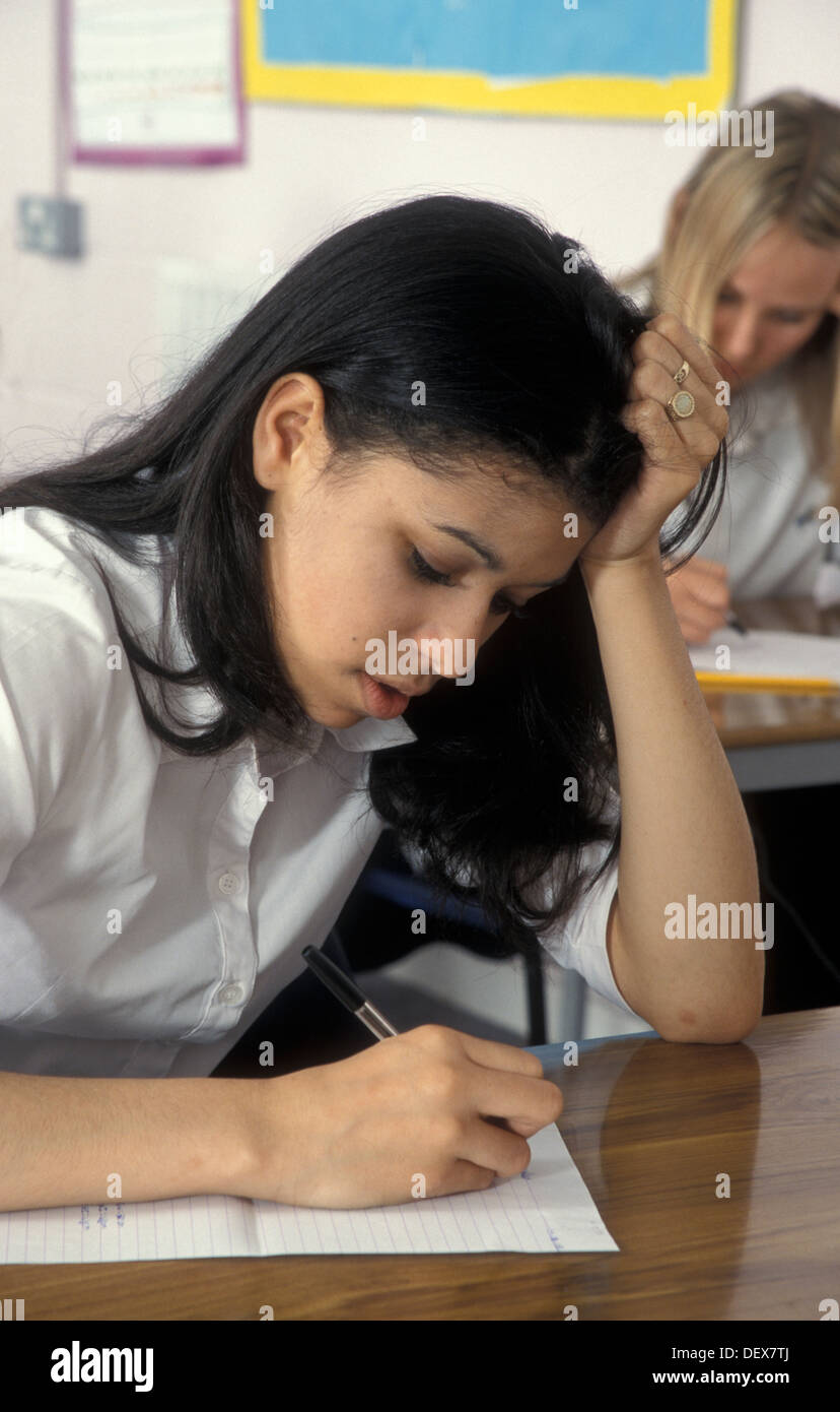 teenage students writing in classroom Stock Photo - Alamy