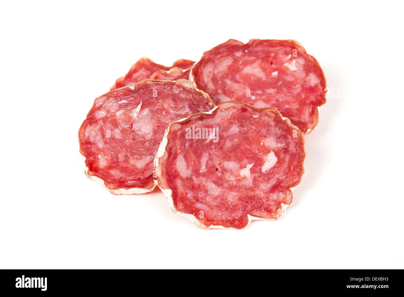 pile of red salami, isolated on a white background Stock Photo - Alamy