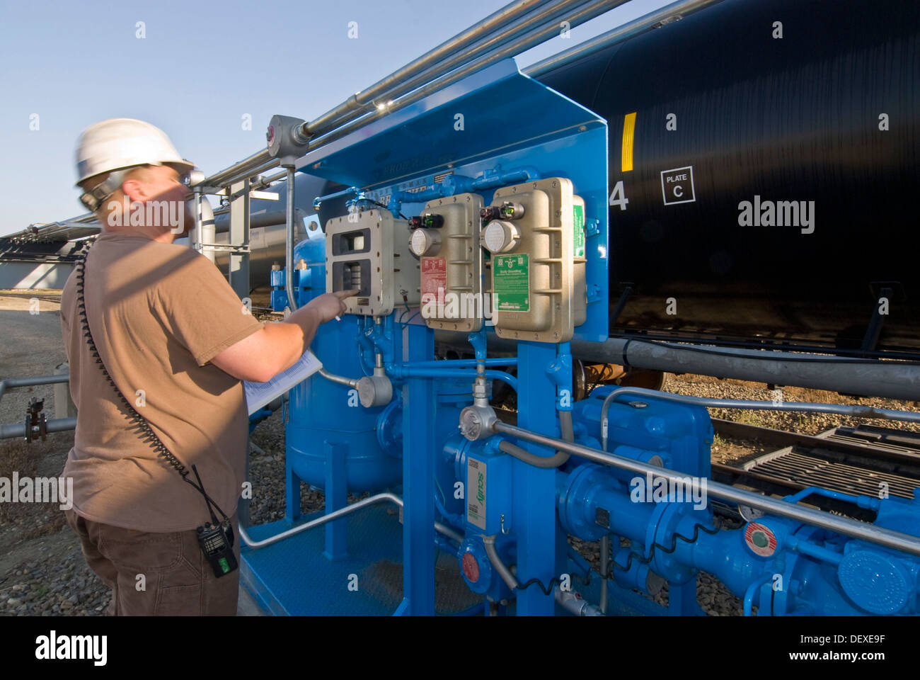 Worker entering loading information before loading rail car with ...