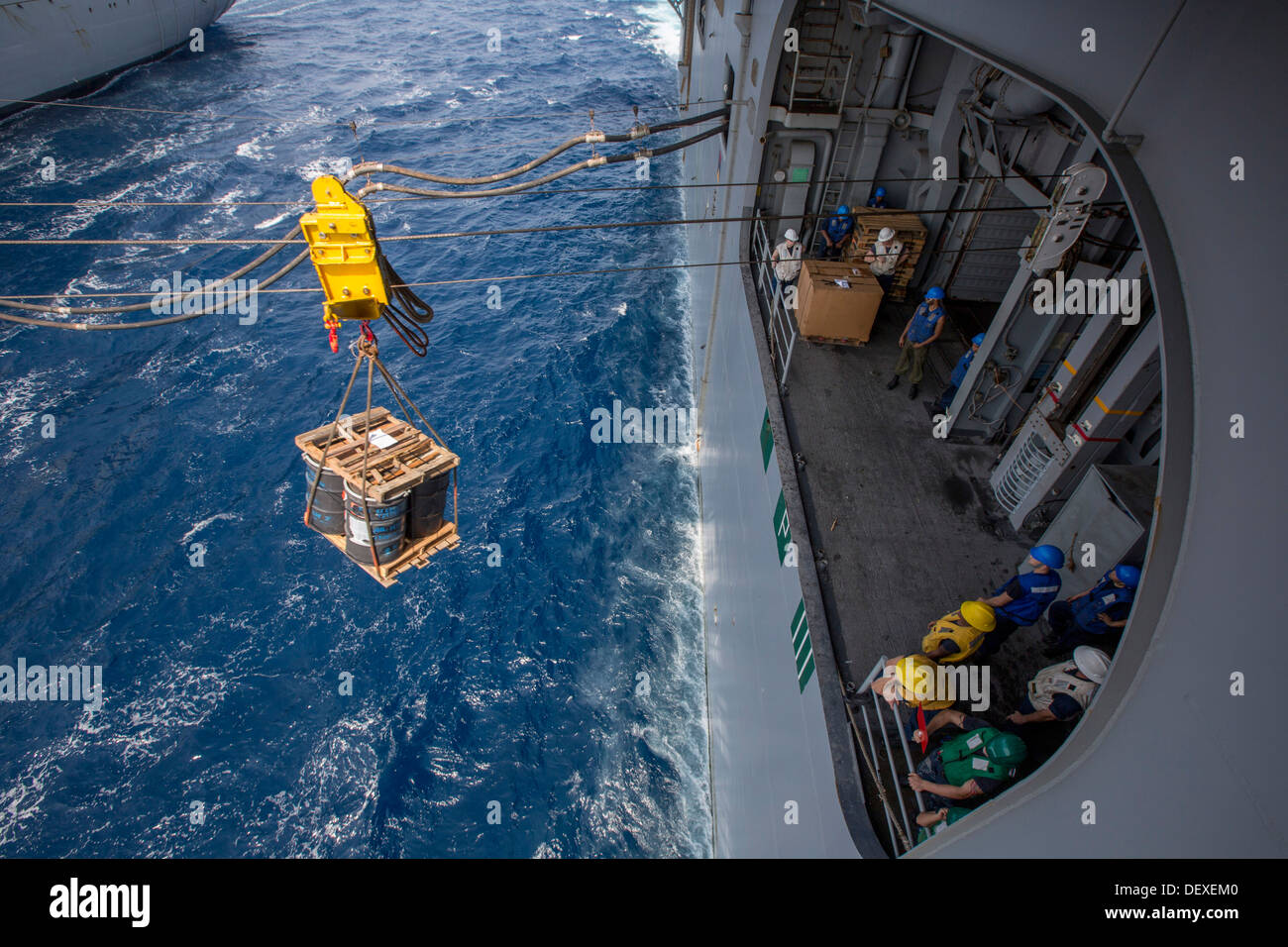 Sailors send cargo from the amphibious assault ship USS Kearsarge (LHD ...
