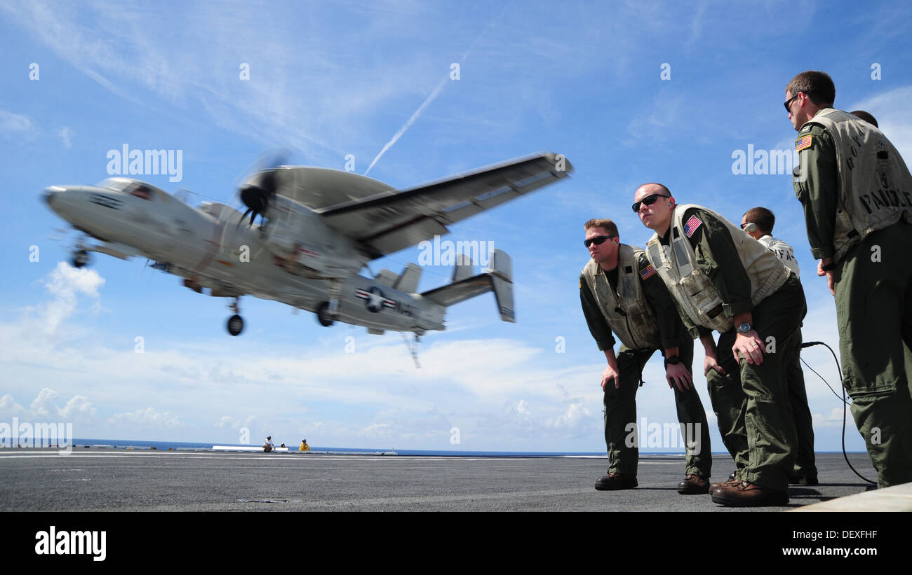 Landing signal officers observe an E-2C Hawkeye from the Liberty Bells ...