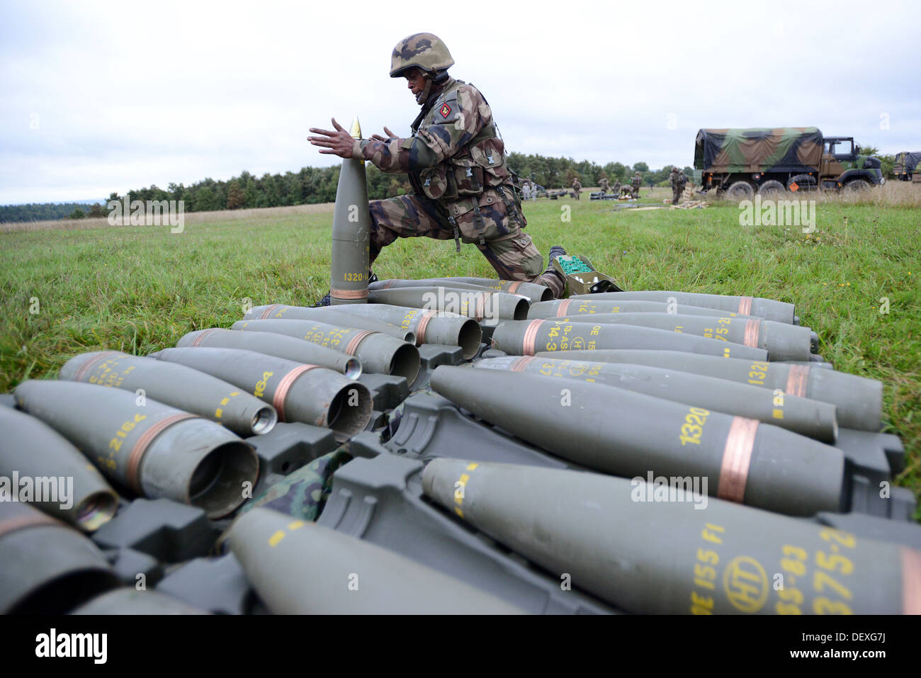 A French Army soldier arms a 155mm round with point detonating fuse as ...