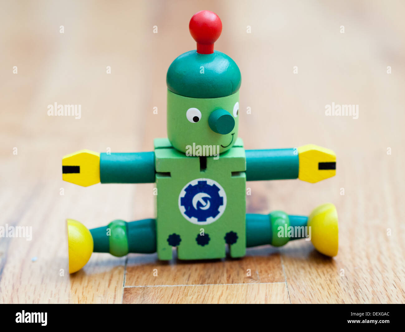A cute little wooden robot does the splits Stock Photo - Alamy