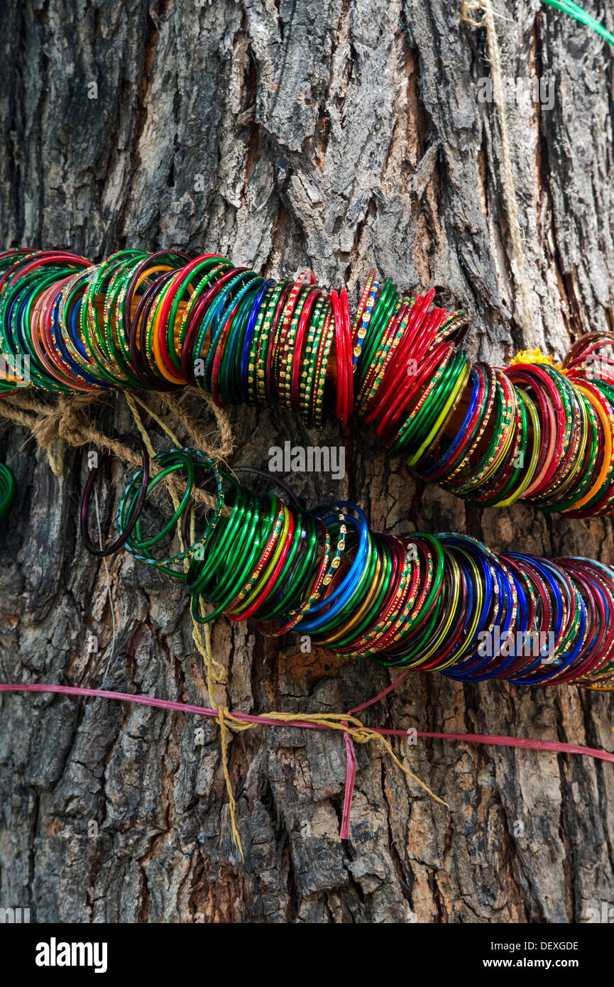 Coloured indian ladies bangles strung up round a wish fulfilling tree ...
