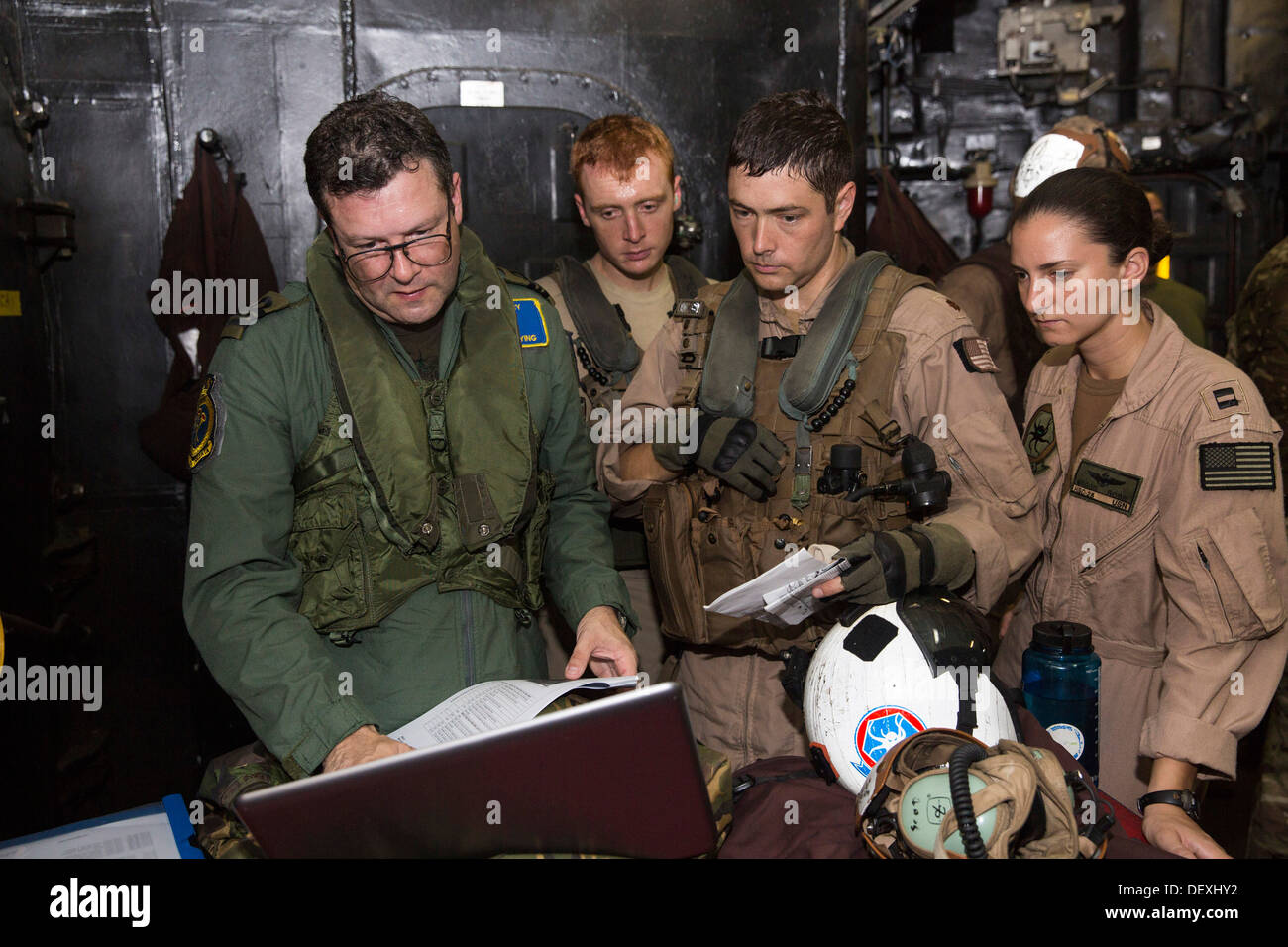 A Royal British military pilot reviews a flight plan with pilots from ...