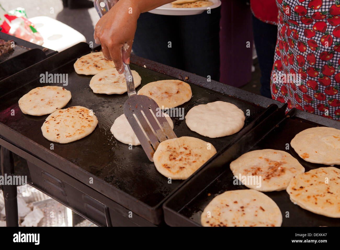 Woman grilling pupusas Stock Photo - Alamy