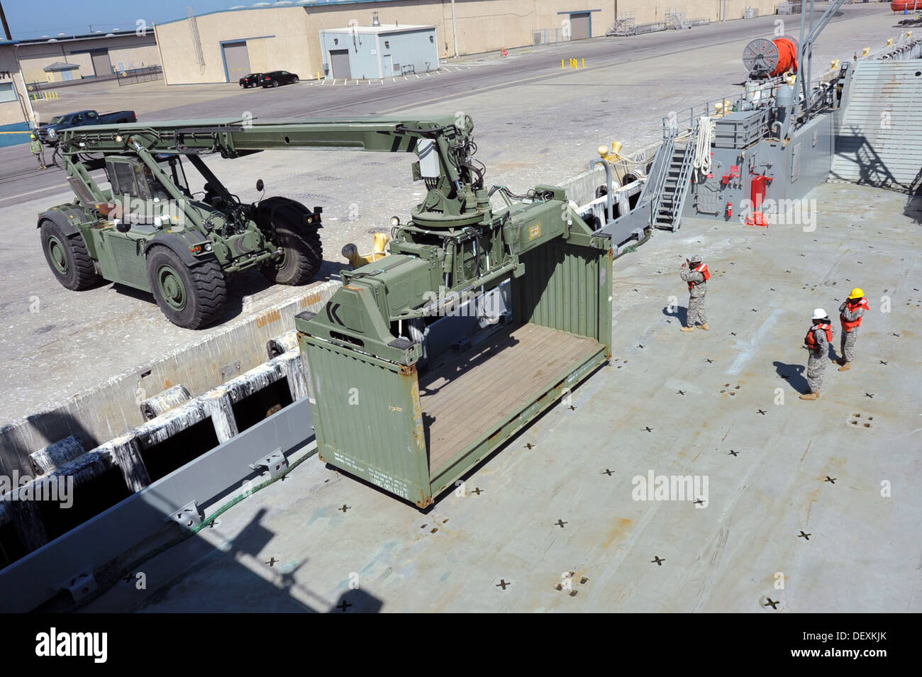 U.S. Army Reserve Soldiers load cargo onto the Landing Craft Utility ...