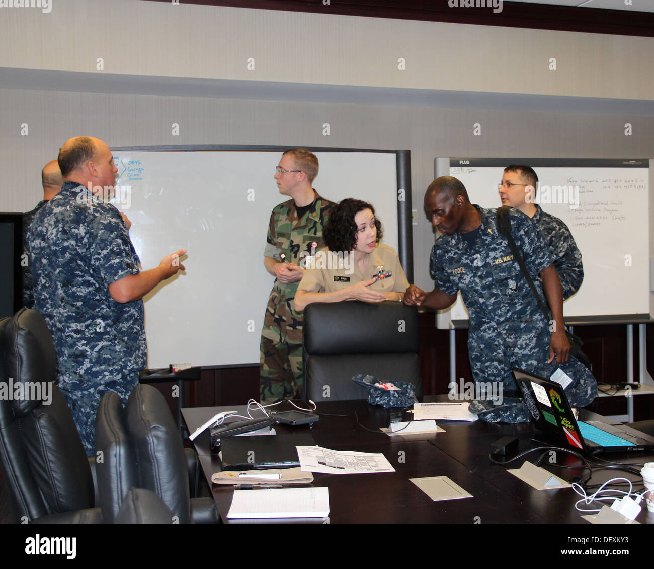 Members of the Emergency Family Assistance Center (EFAC) team discuss ...