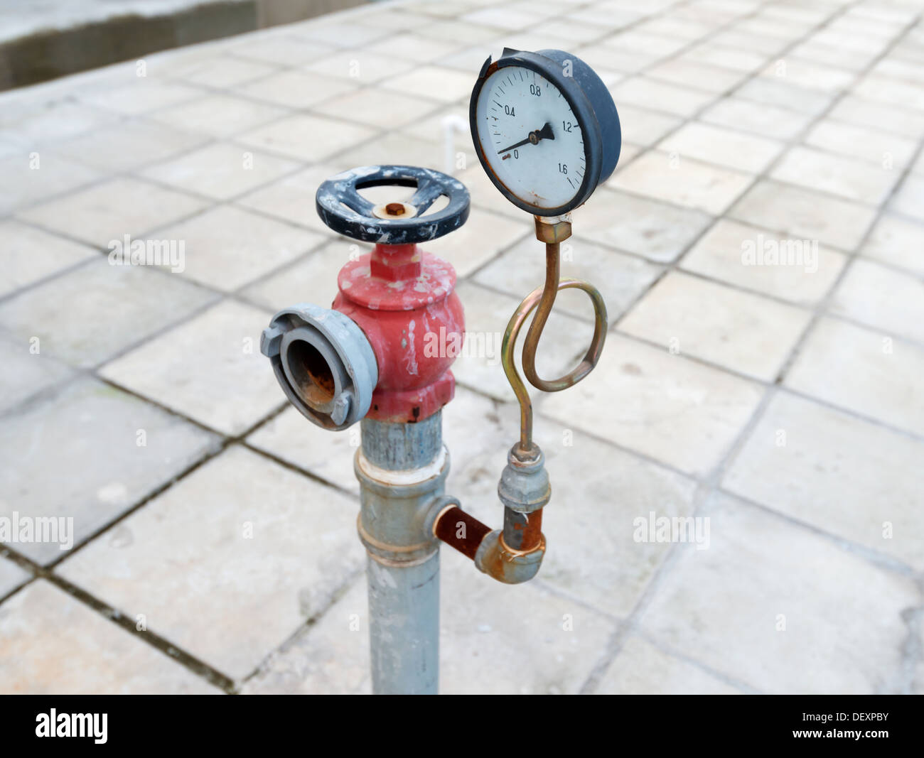 Closeup of manometer, pipes and faucet valves of heating system in a ...
