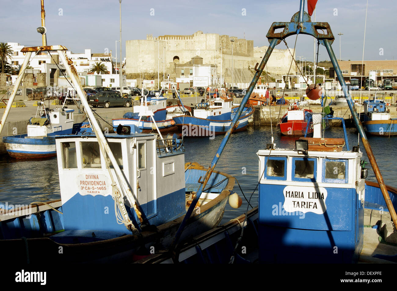 Fishing harbour with the Moorish castle of Guzmán el Bueno in ...
